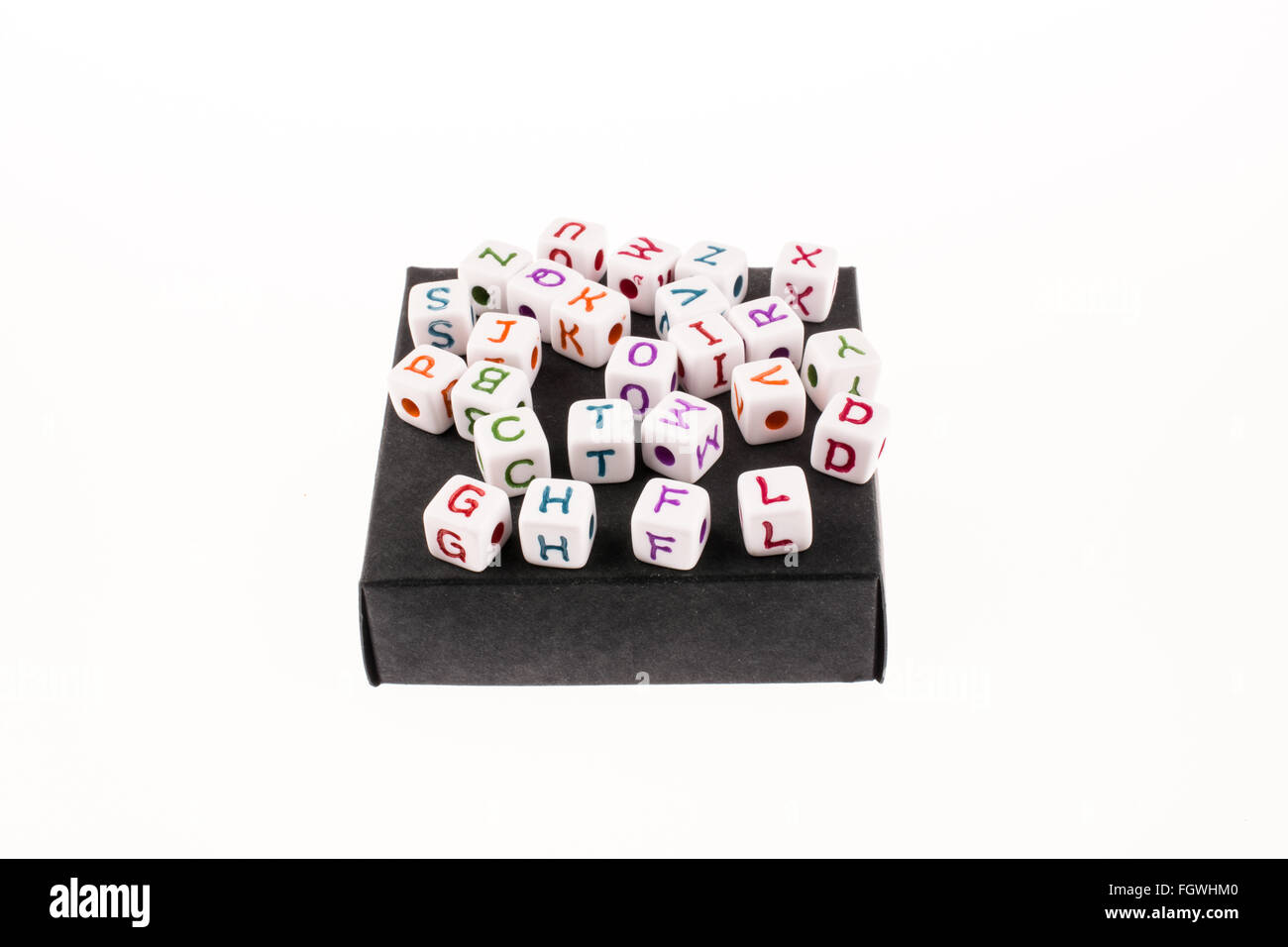 letter cubes placed on a box on a white background Stock Photo - Alamy