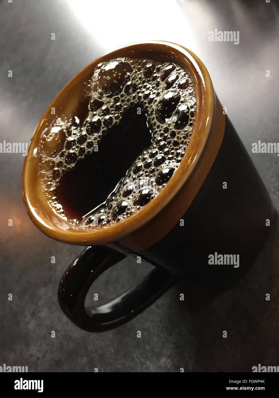 Foaming mug of coffee Stock Photo - Alamy