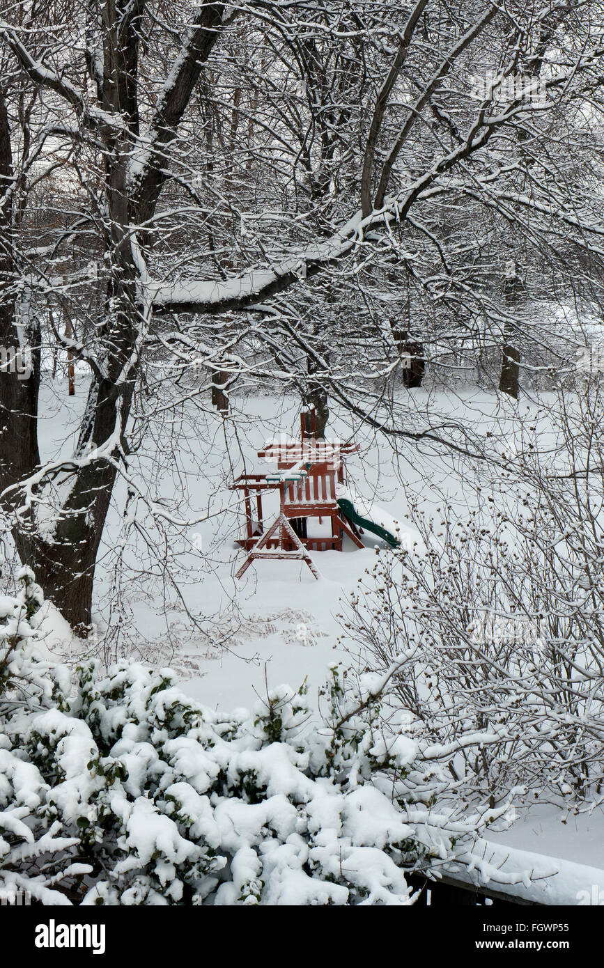 Snowy backyard with swing set Stock Photo - Alamy