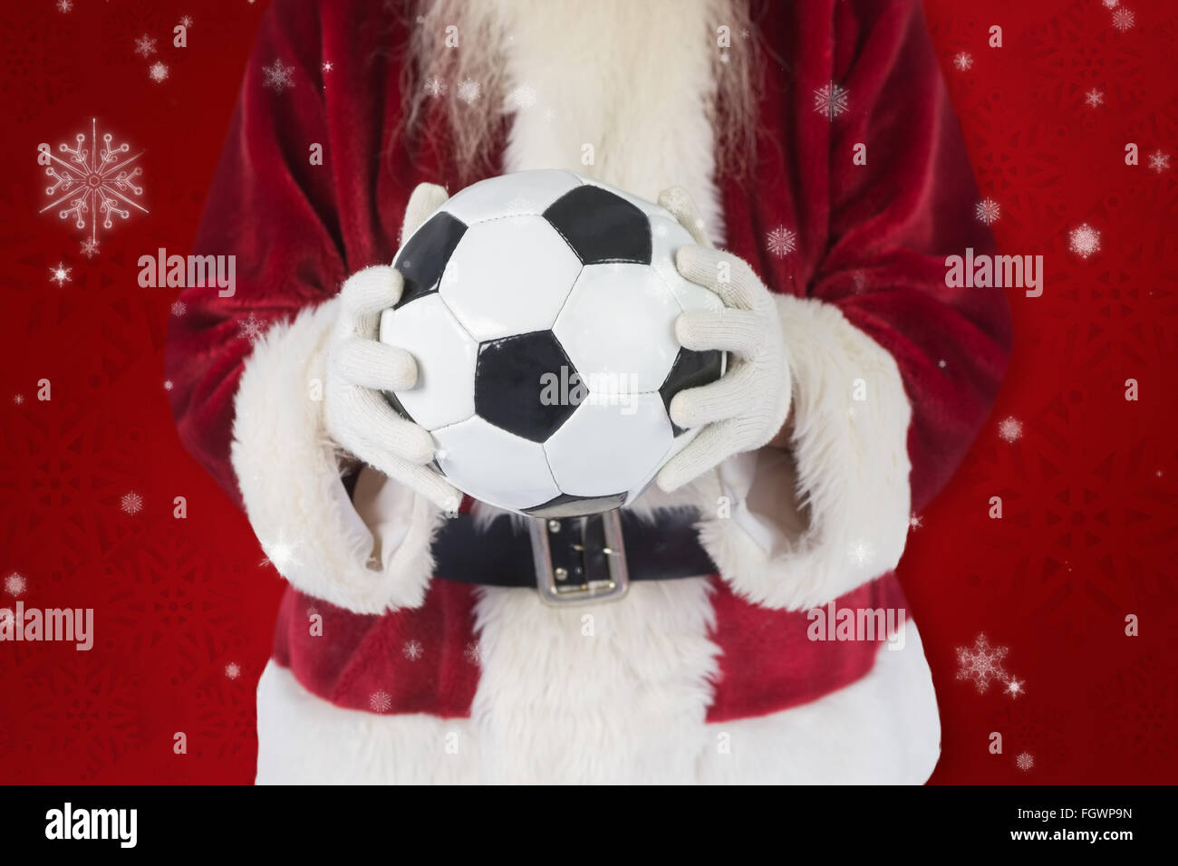Composite image of santa holds a classic football Stock Photo - Alamy