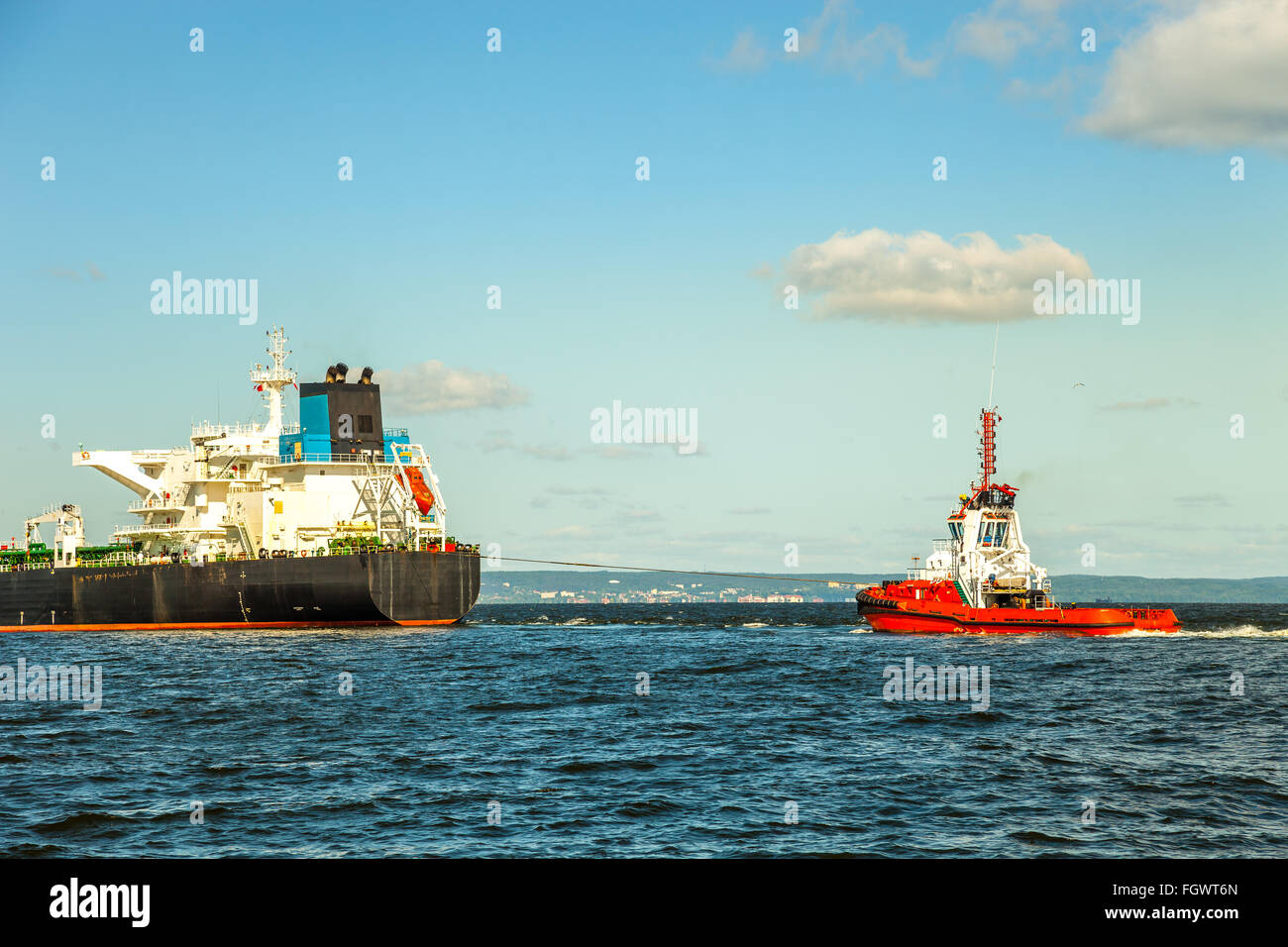 Tugboat pulling the tanker at sea in the morning Stock Photo - Alamy