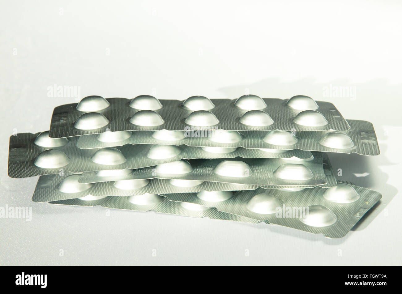 silver set of pills isolated on white image Stock Photo - Alamy