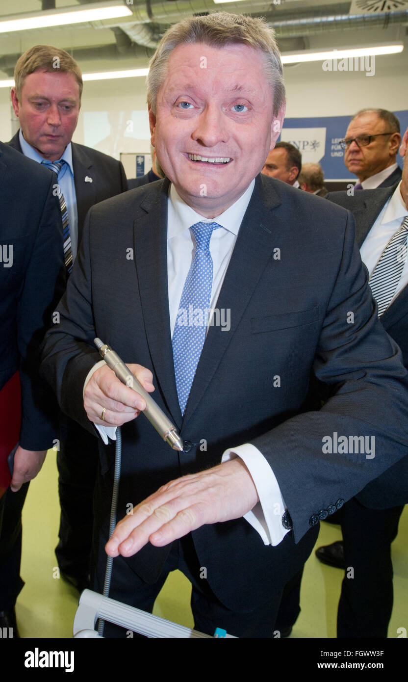 German federal health minister Hermann Groehe holds a silver plasma pen ...