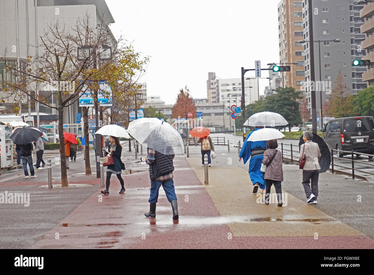 People walking on the pavement in the rain, Fukuoka, Japan Stock Photo ...