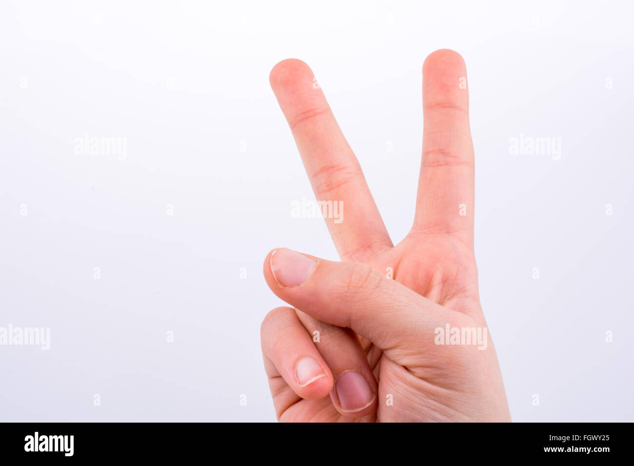 Hand making Victory Symbol on a white background Stock Photo - Alamy