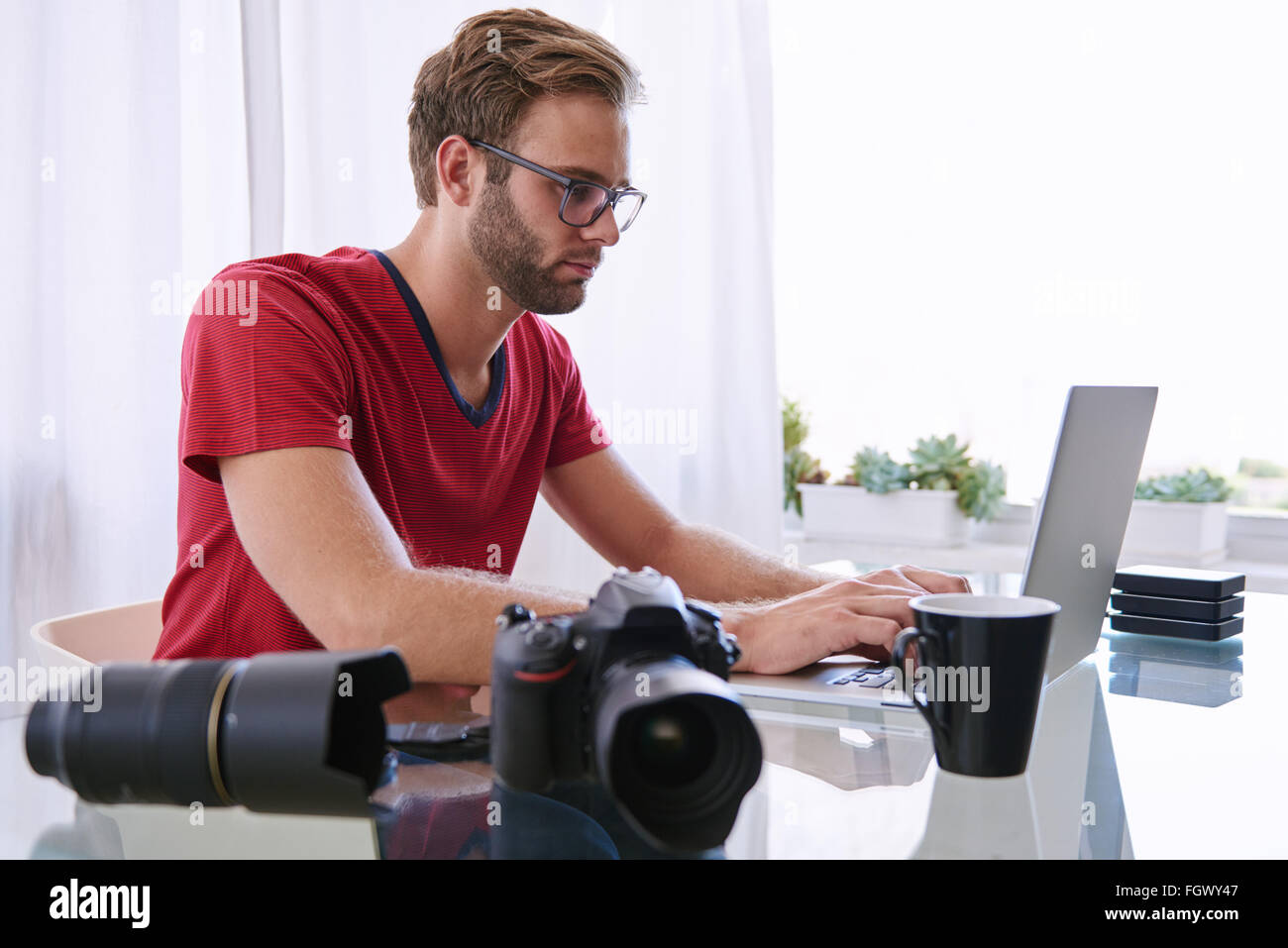 Young caucasian image enthusiast hard at work Stock Photo - Alamy