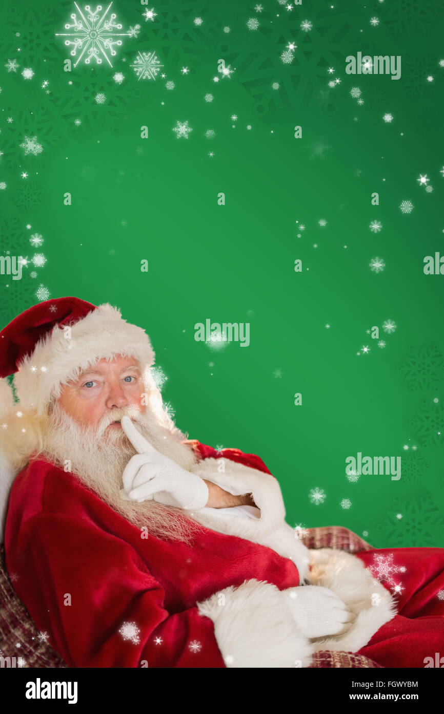 Composite image of santa asking for quiet Stock Photo - Alamy