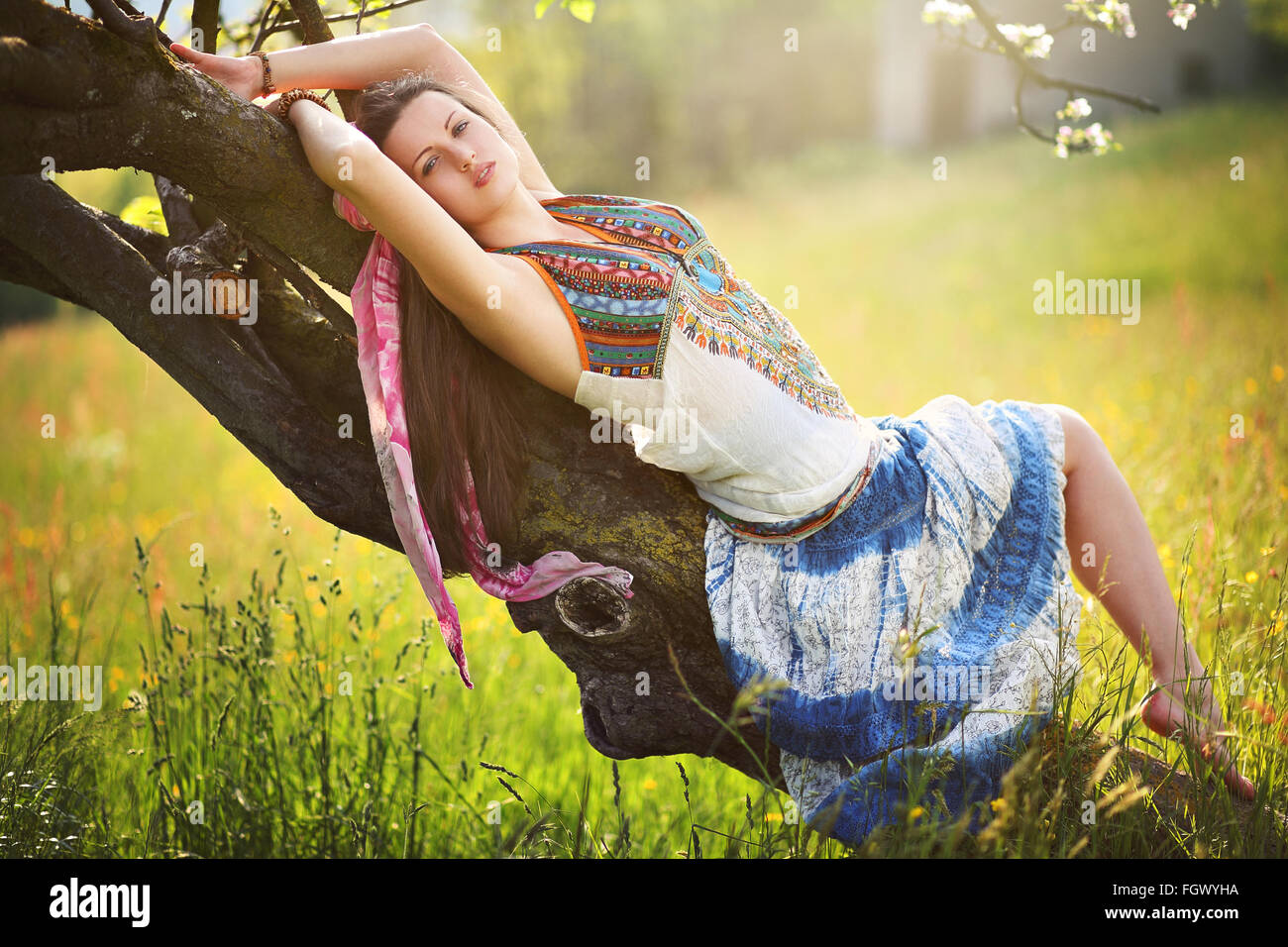 Beautiful romantic hippie posing in spring meadow. Gypsy dress Stock ...