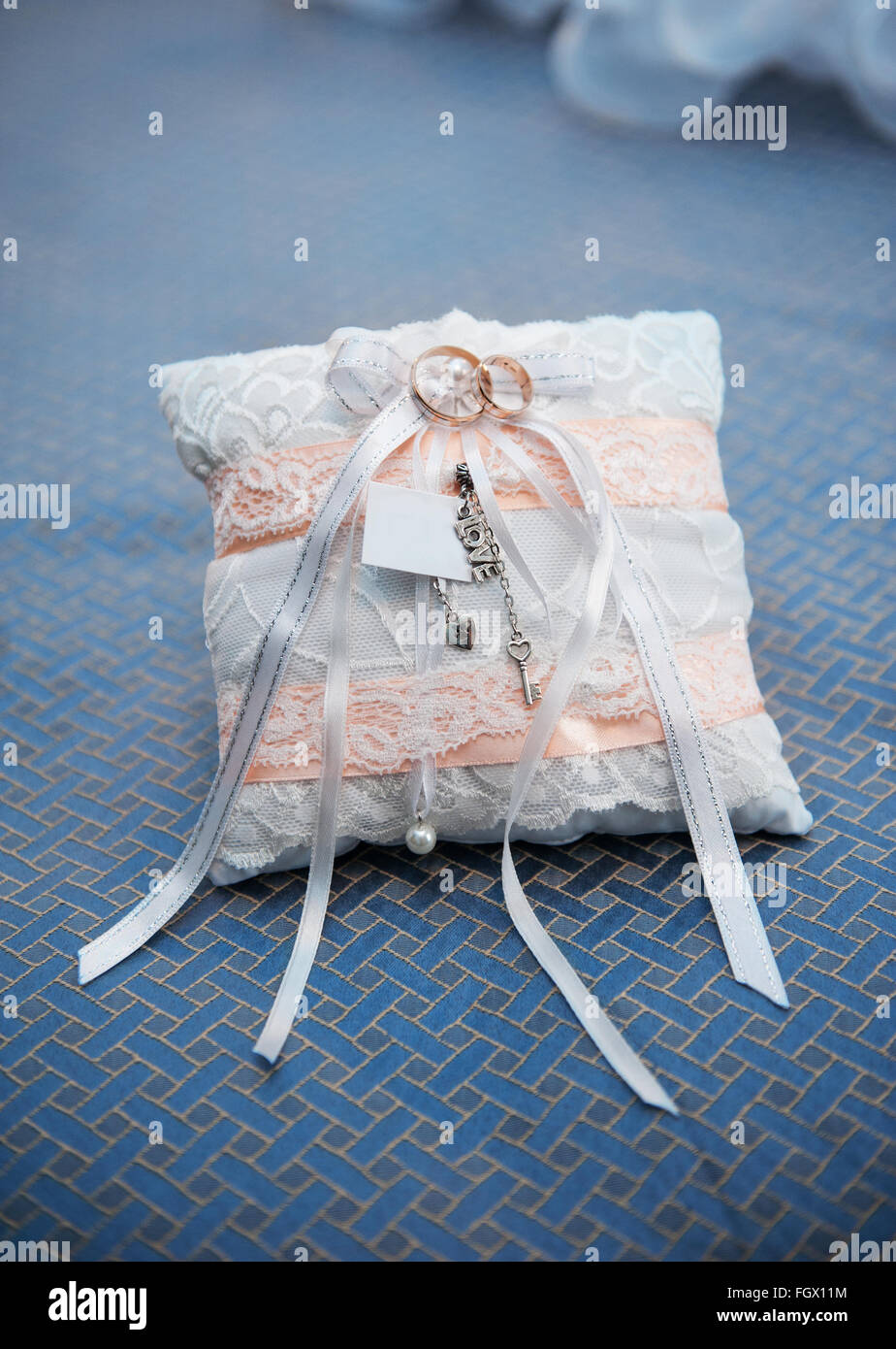 Beautiful cushion with wedding rings bride and groom Stock Photo - Alamy