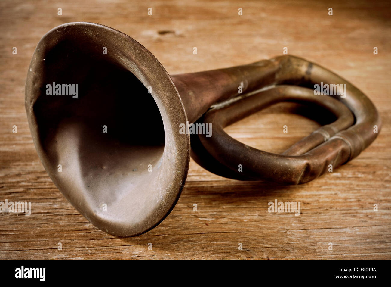 closeup of an old bugle on a rustic wooden surface Stock Photo - Alamy