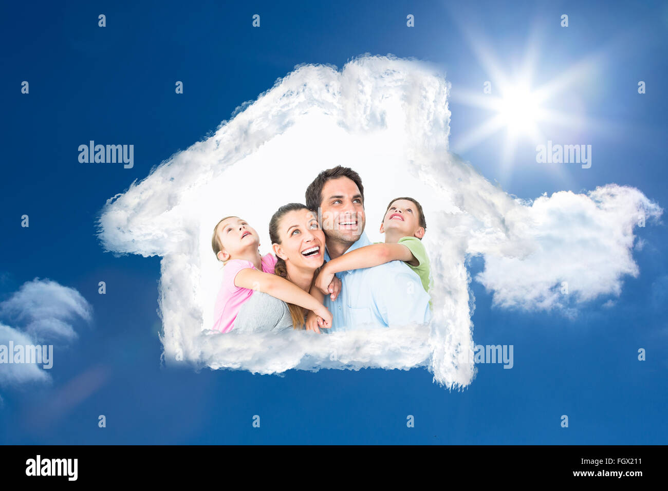 Composite image of happy young family looking up together Stock Photo ...