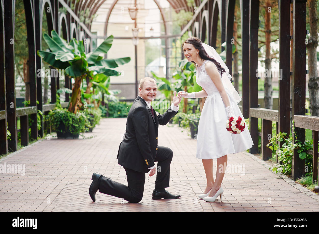 Groom on one knee hi-res stock photography and images - Alamy