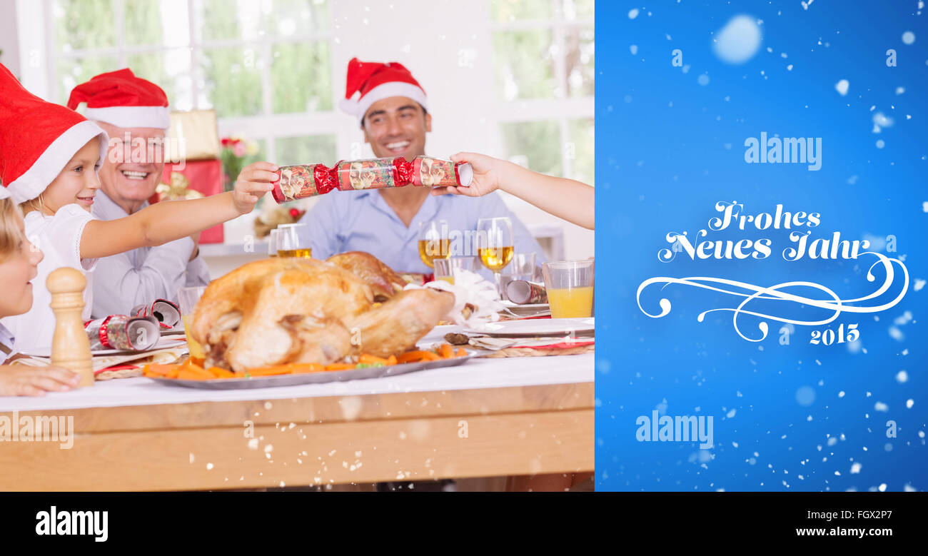 Composite image of siblings pulling a christmas cracker Stock Photo - Alamy