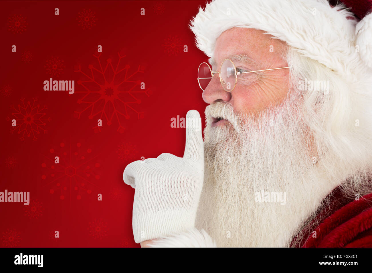 Composite image of santa claus making quiet sign Stock Photo - Alamy