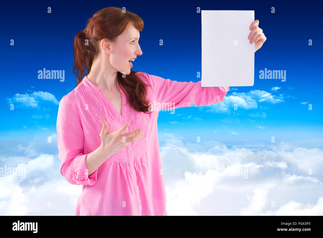 Composite image of woman shocked looking at paper Stock Photo - Alamy