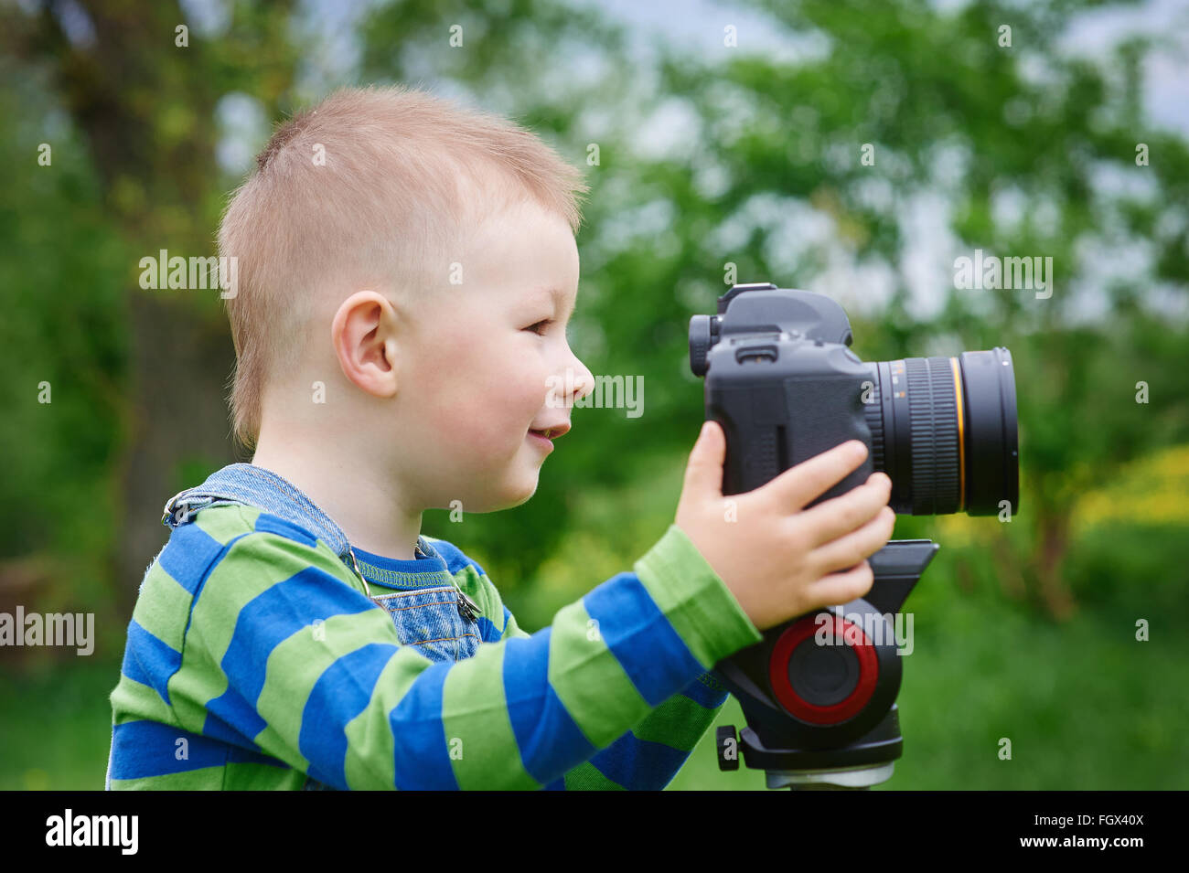 Little boy with an camera shooting outdoor Stock Photo - Alamy