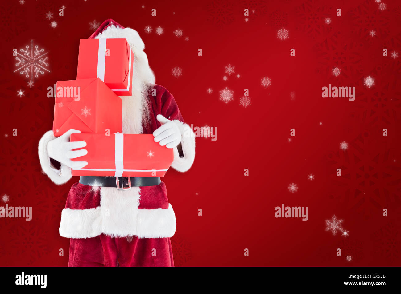 Composite image of santa covers his face with presents Stock Photo - Alamy