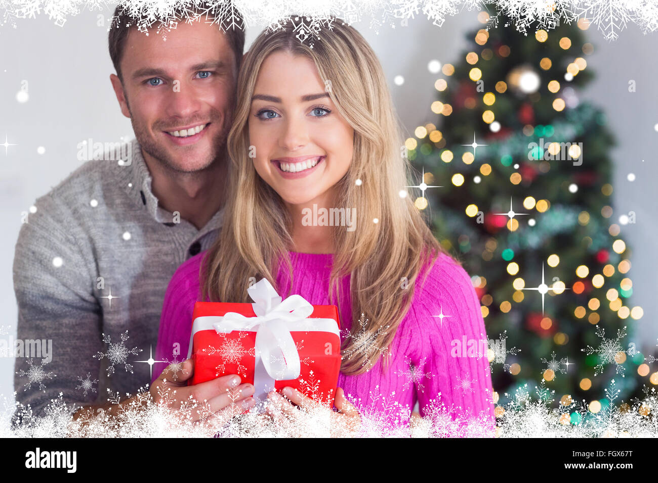 Composite image of happy couple holding each other Stock Photo - Alamy