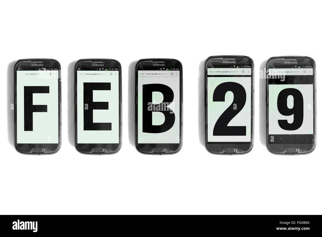 Feb 29 written on the screens of smartphones photographed against a ...