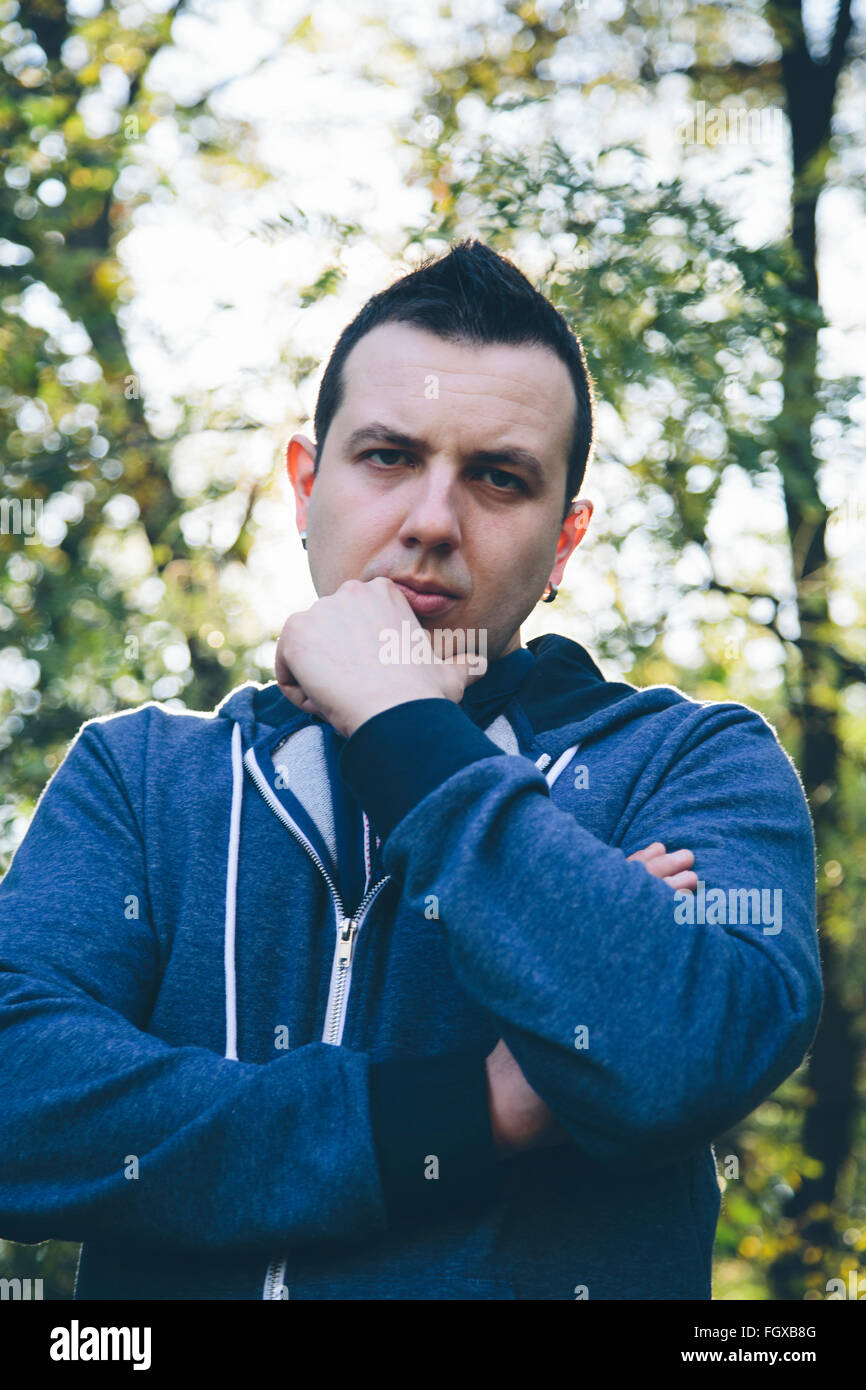 Young man standing hi-res stock photography and images - Alamy