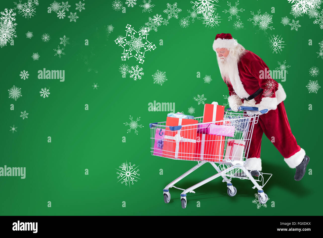 Composite image of santa rides on a shopping cart Stock Photo - Alamy