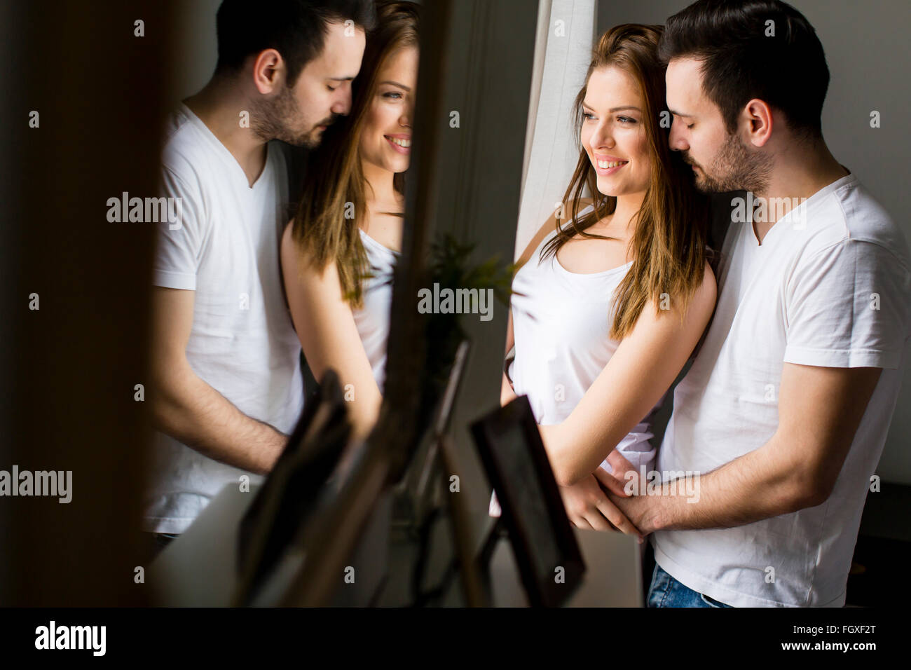 Loving couple by the window Stock Photo - Alamy