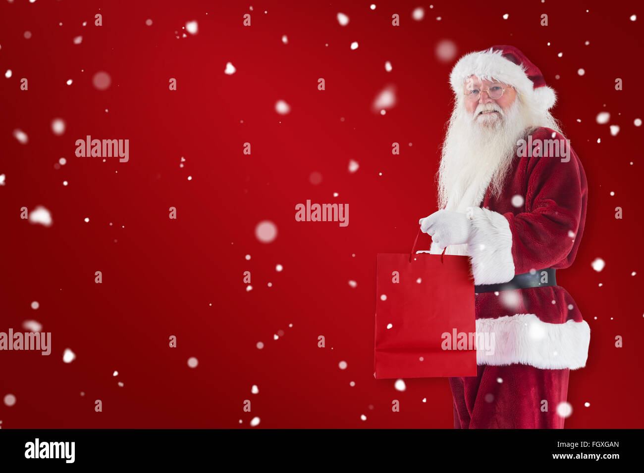 Composite image of santa carries red gift bag Stock Photo - Alamy