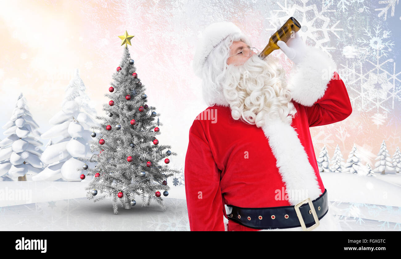 Composite image of father christmas drinking a beer Stock Photo - Alamy