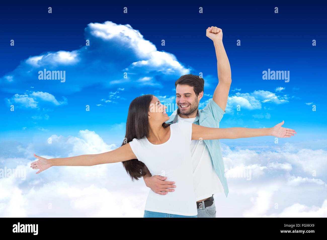 Composite image of happy casual couple cheering together Stock Photo ...