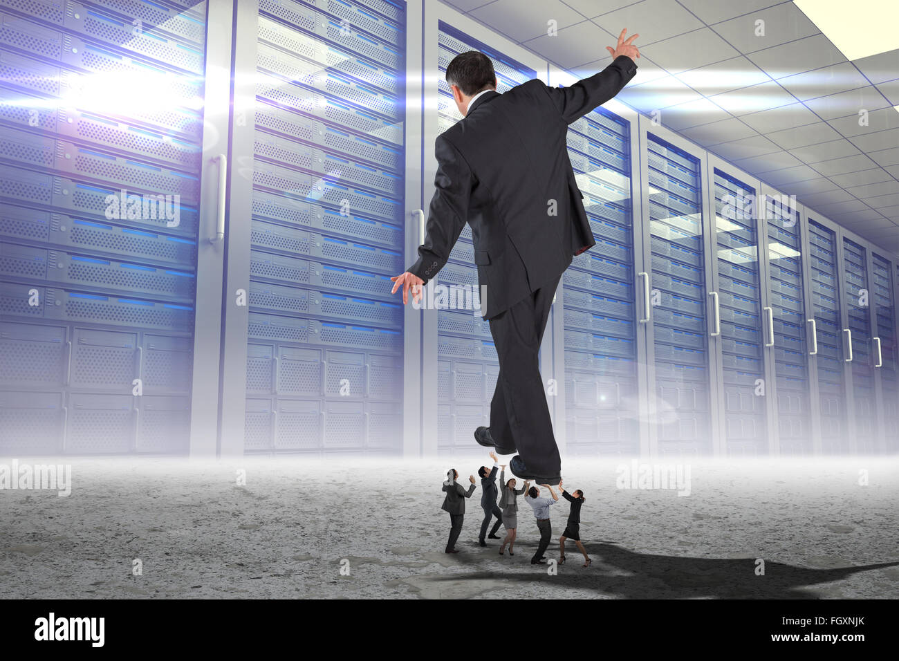 Composite image of business people supporting boss Stock Photo - Alamy