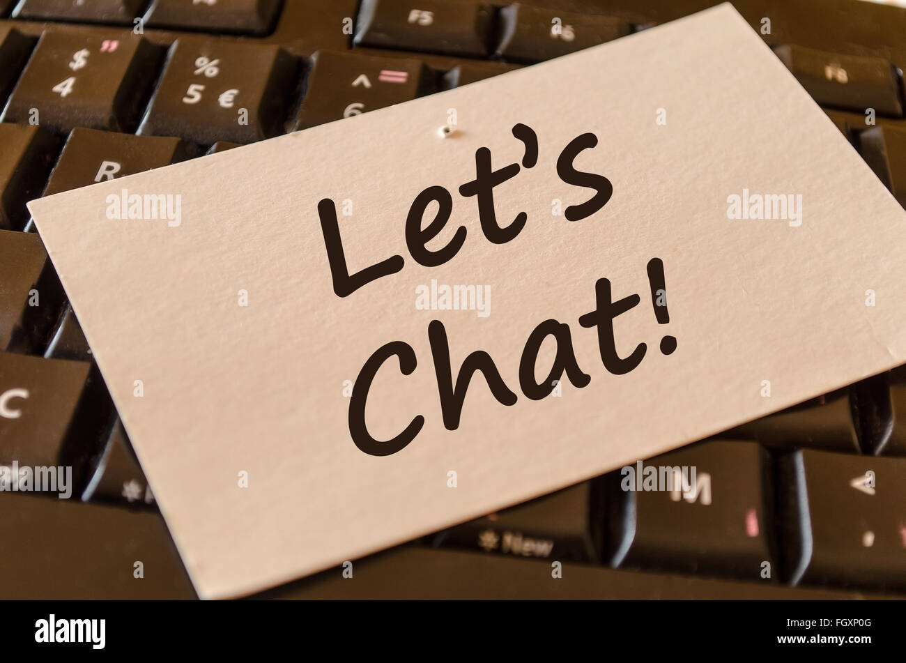 Computer Keyboard with white note and text let's chat Stock Photo - Alamy