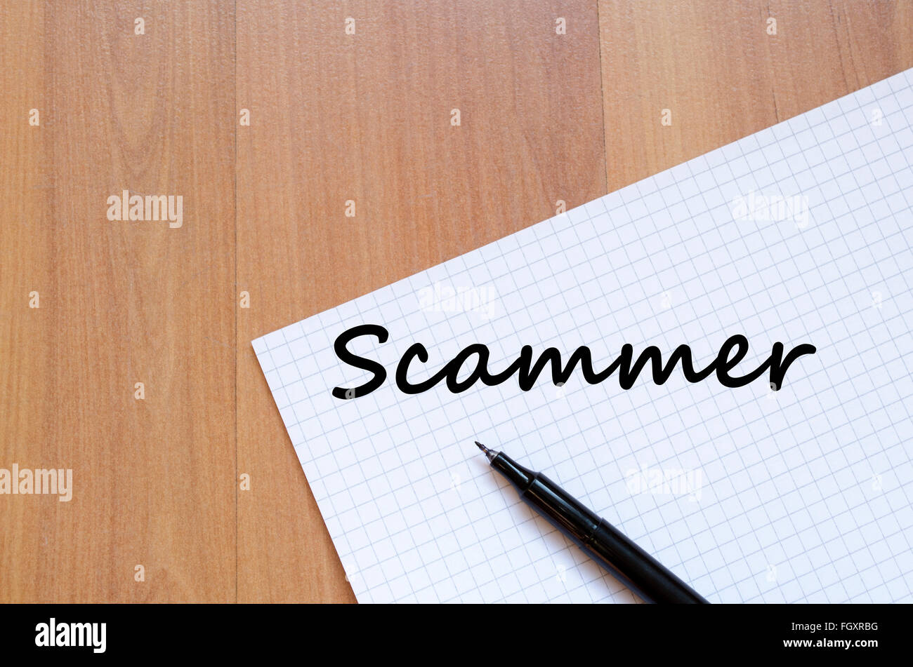Scammer text concept write on notebook with pen Stock Photo - Alamy