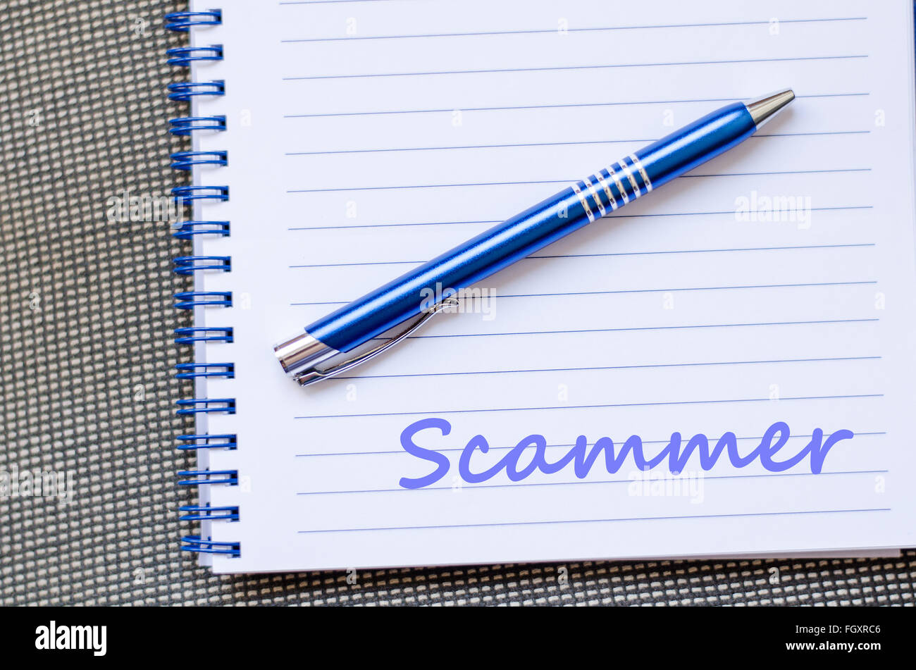 Scammer text concept write on notebook with pen Stock Photo - Alamy