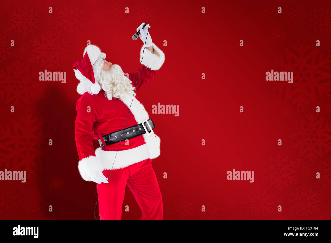 Composite image of happy santa claus singing with microphone Stock ...