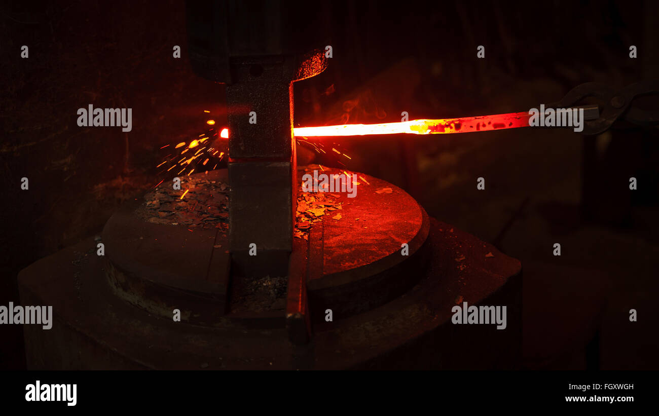 Blacksmith bending hot iron Stock Photo - Alamy