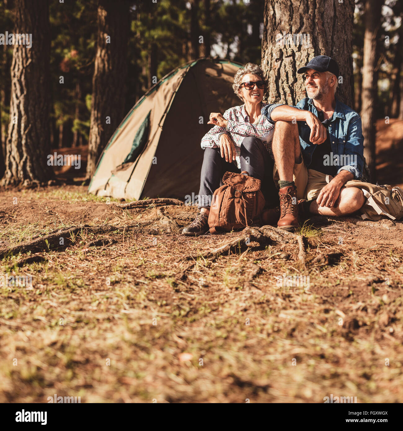 Two women sitting under tree hi-res stock photography and images - Alamy