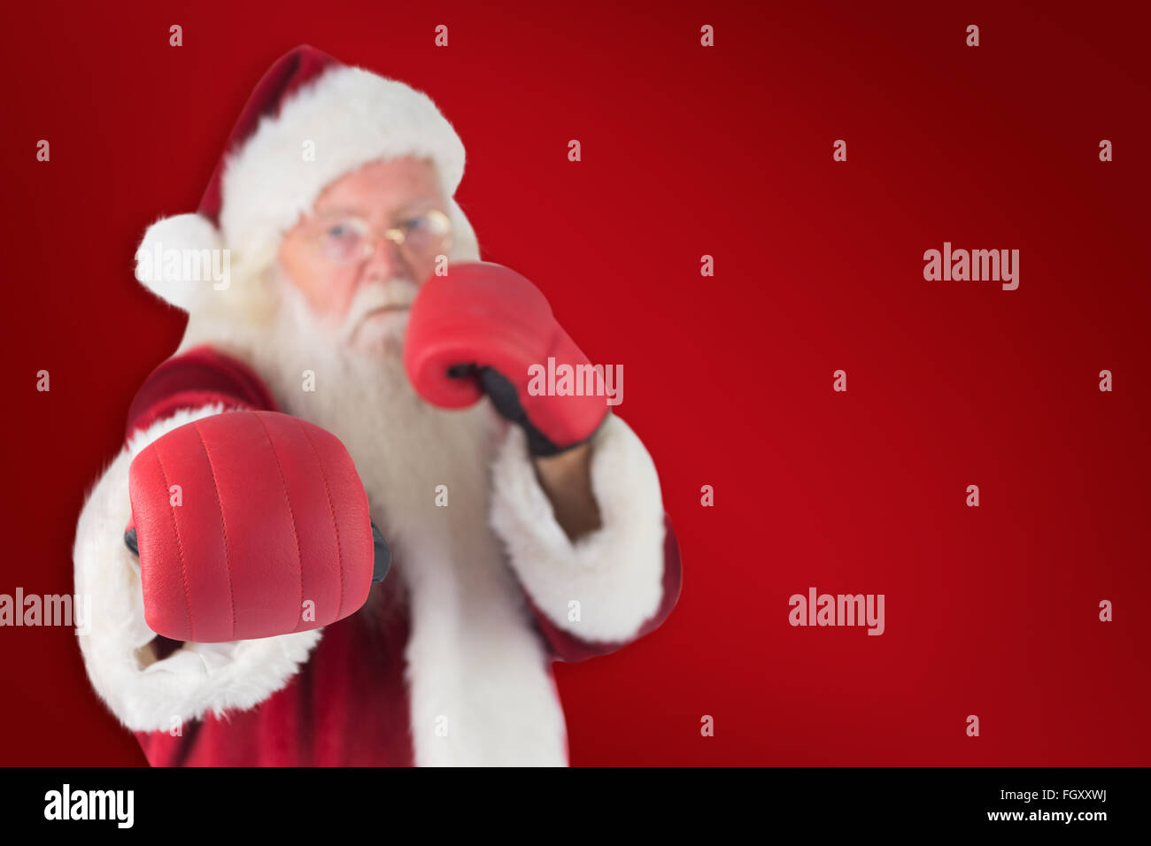 Composite image of santa claus punches with his right Stock Photo - Alamy