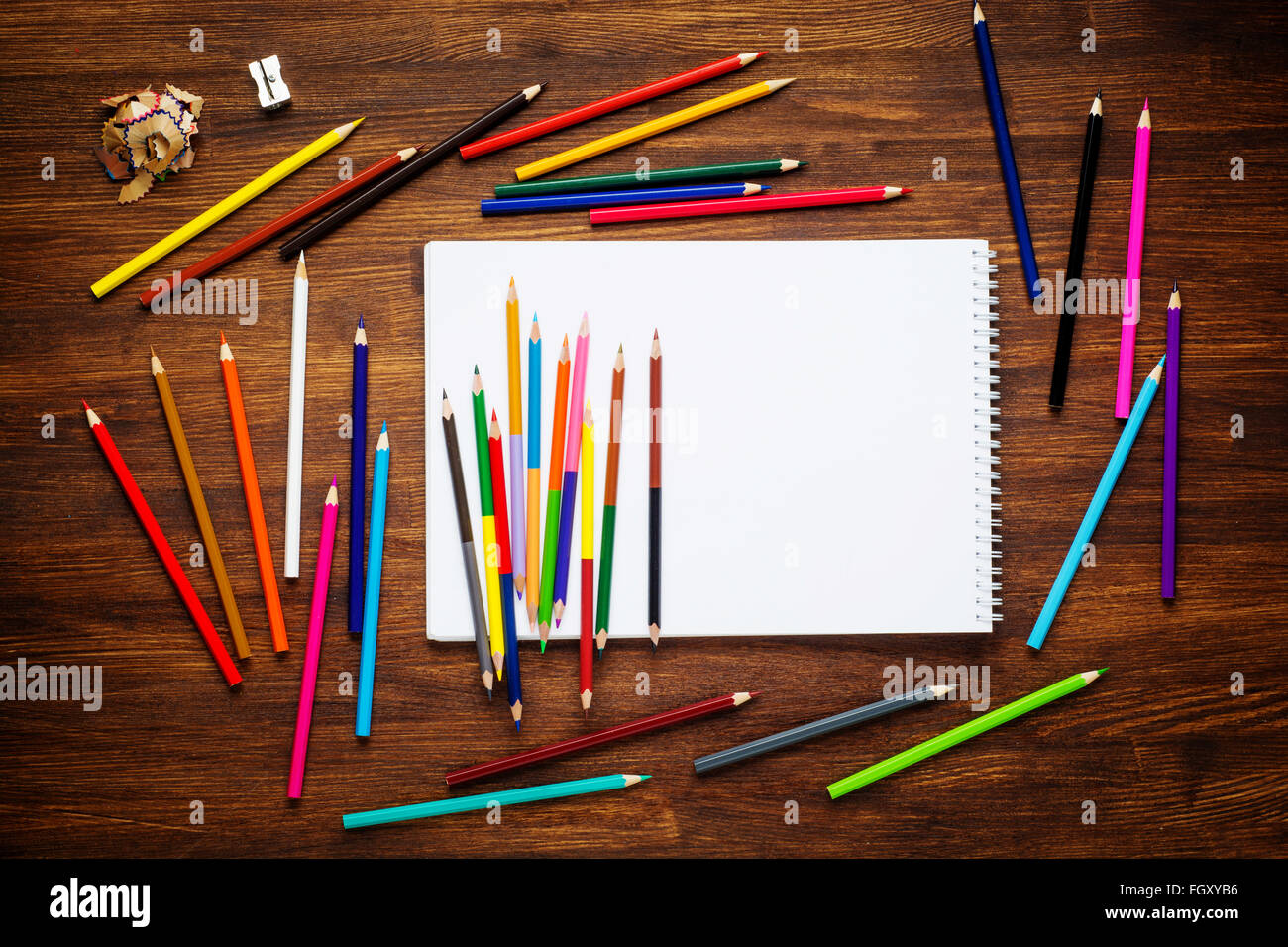 Colorful Pencils on wooden table with paper. Top view Stock Photo - Alamy