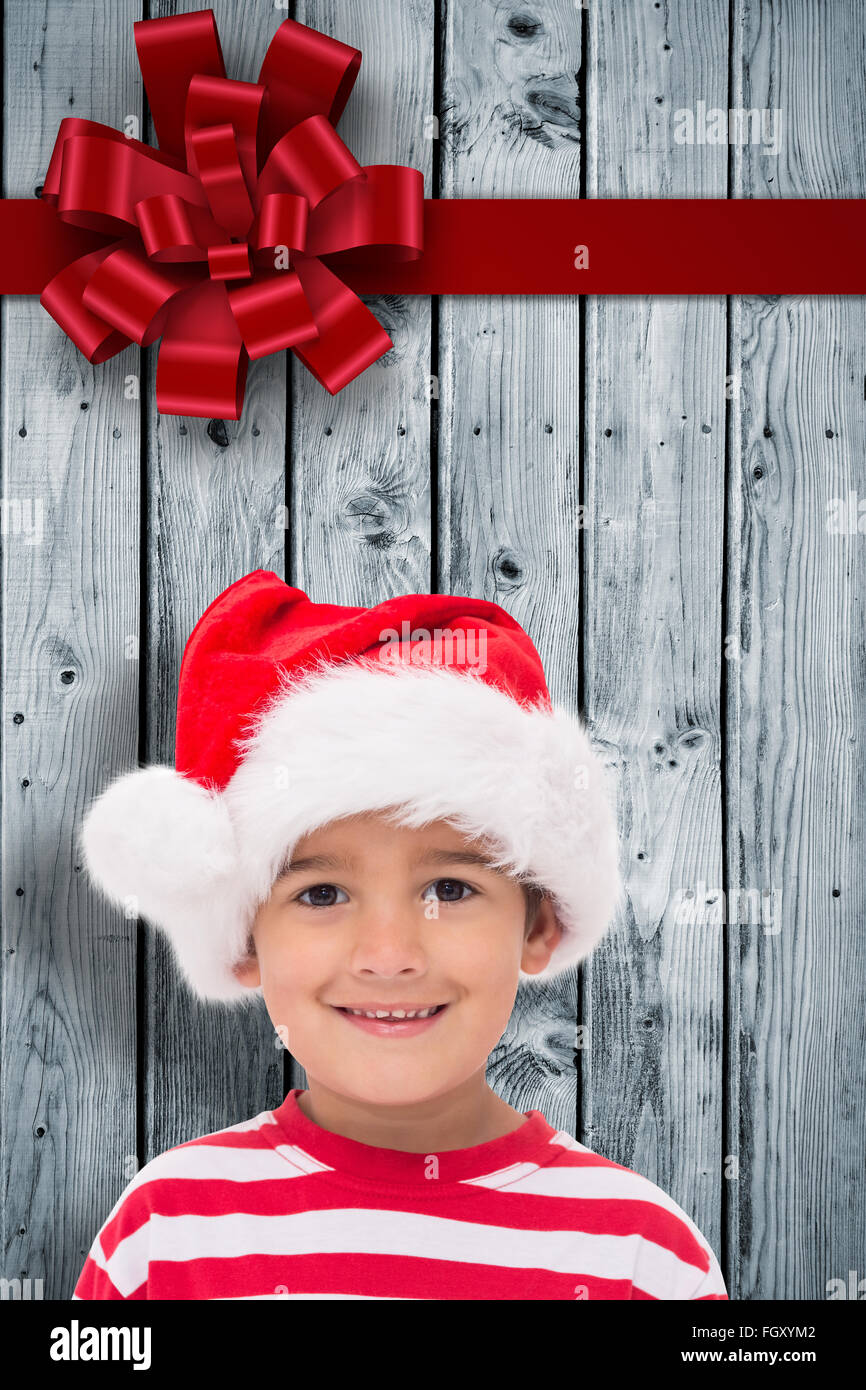 Composite image of cute little boy in santa hat Stock Photo - Alamy