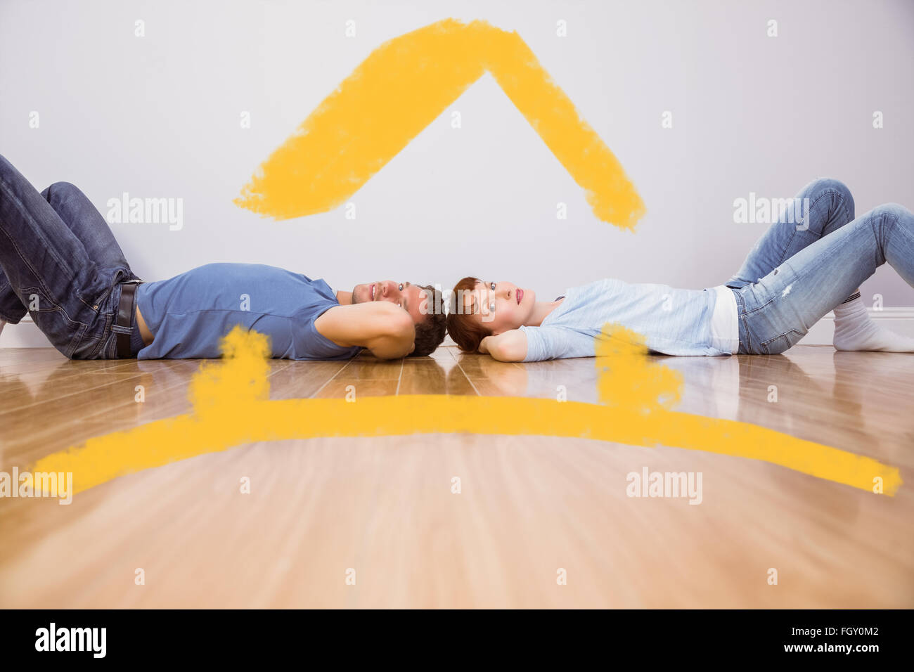 Composite image of couple lying on the floor Stock Photo - Alamy