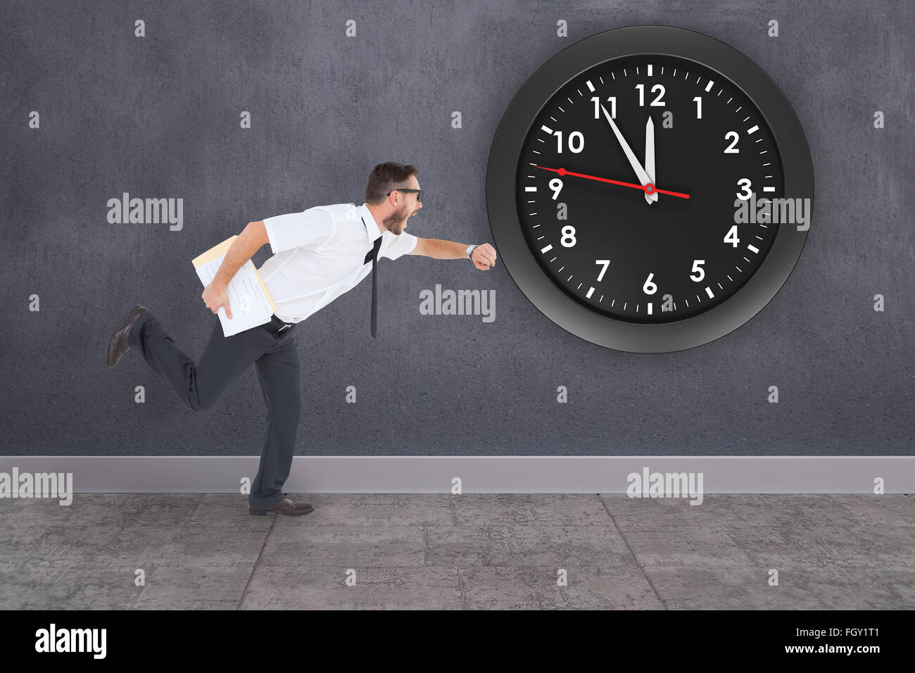 Composite image of geeky young businessman running late Stock Photo - Alamy