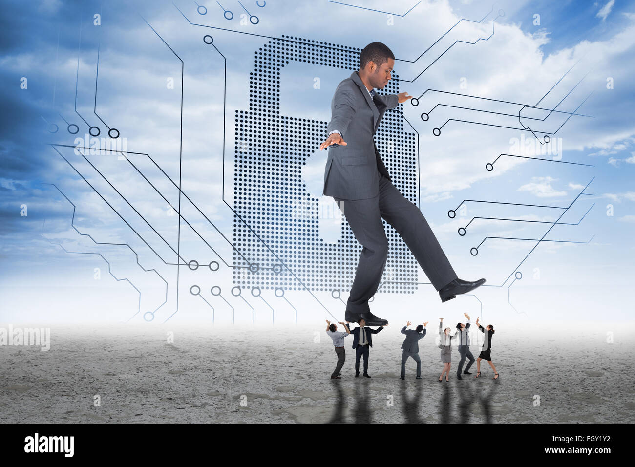 Composite image of business people supporting boss Stock Photo - Alamy