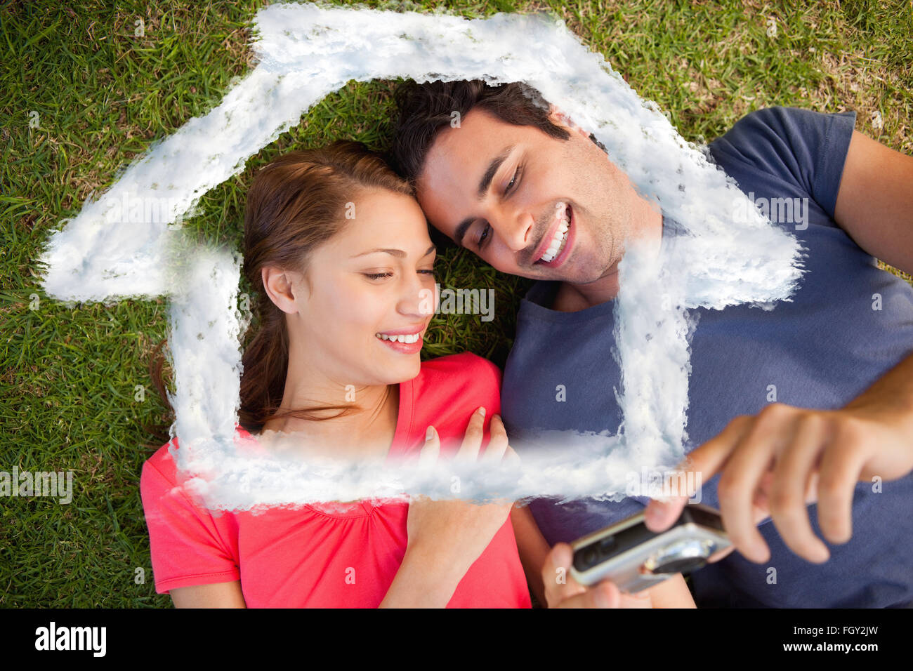 Composite image of two smiling friends looking at photos on a camera ...