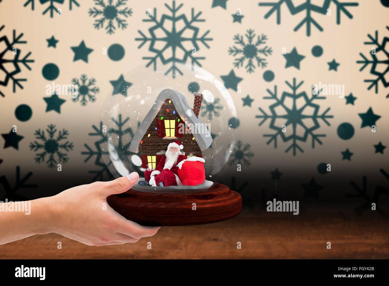 Composite image of hand holding snow globe Stock Photo - Alamy