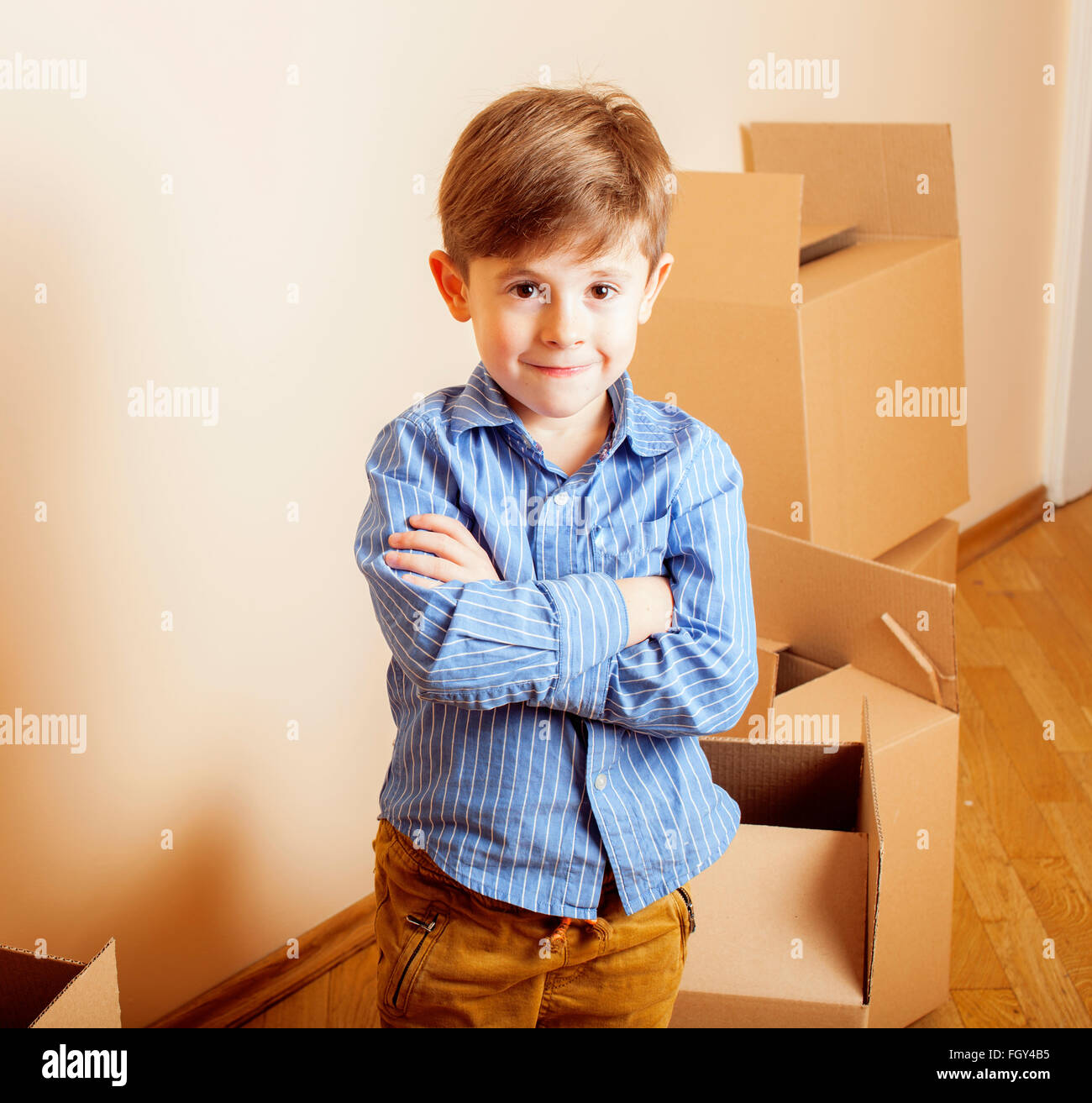 little cute boy in empty room, remoove to new house. home alone emong ...