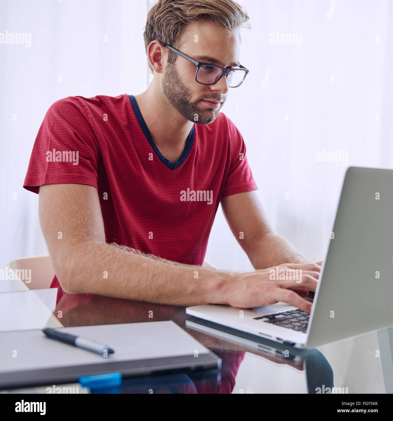 Man concentrating on getting his work done Stock Photo - Alamy