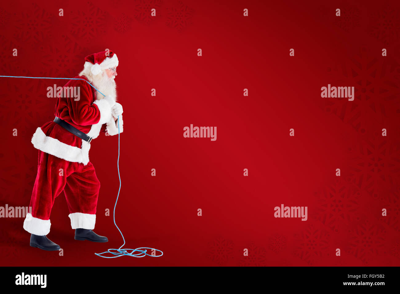 Composite image of santa claus pulling rope Stock Photo - Alamy
