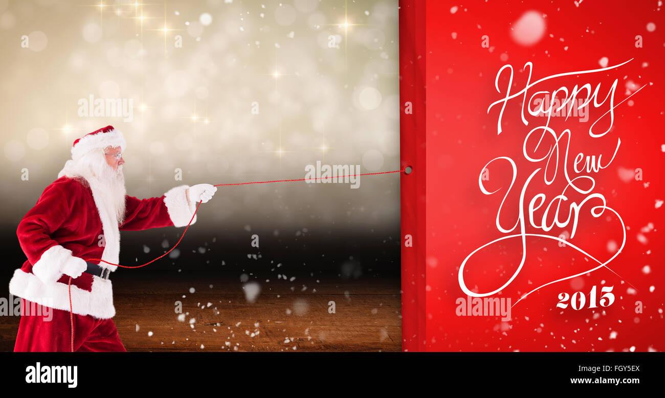Composite image of santa claus pulling a rope Stock Photo - Alamy