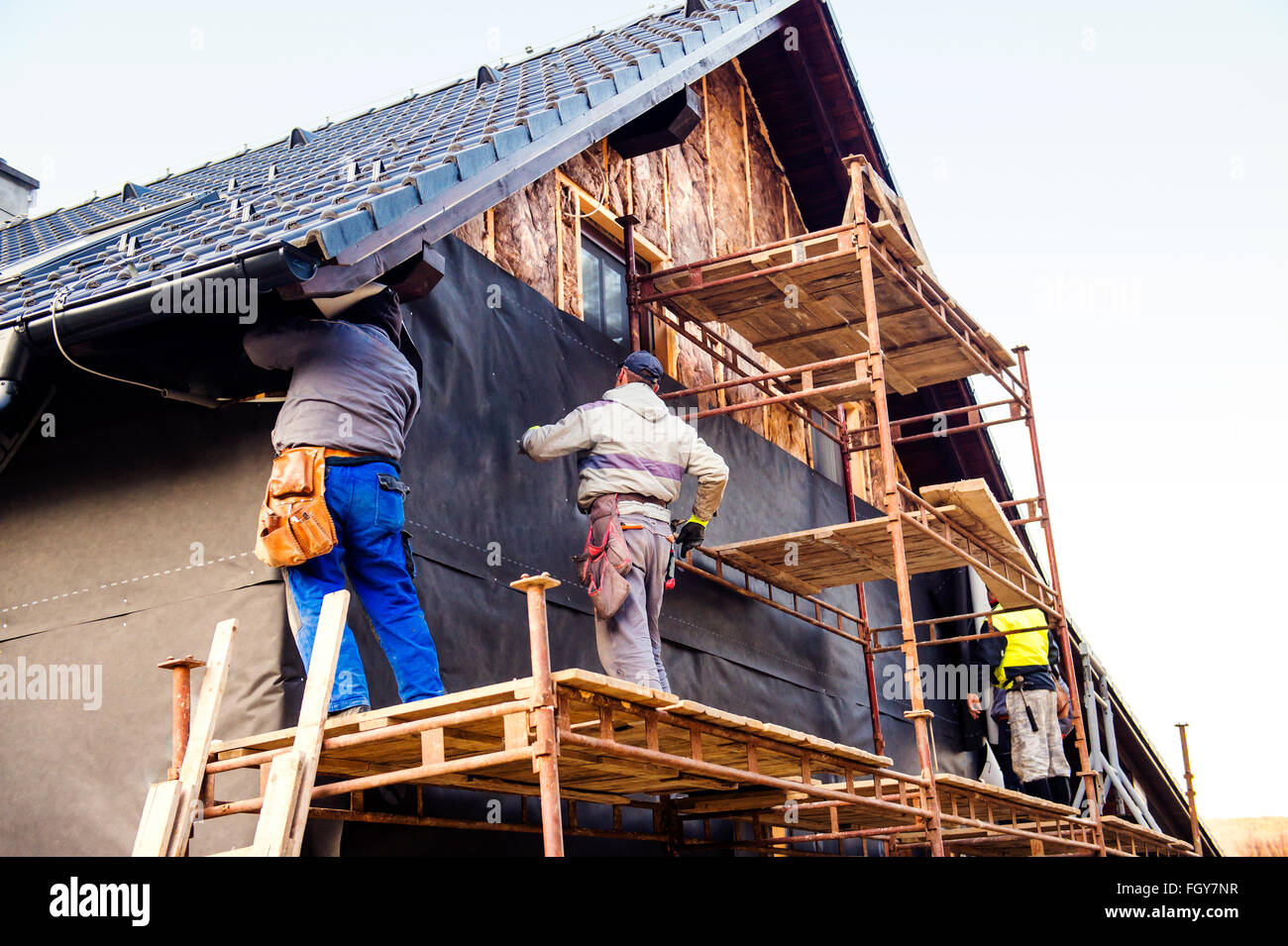Construction workers thermally insulating house with glass wool Stock ...