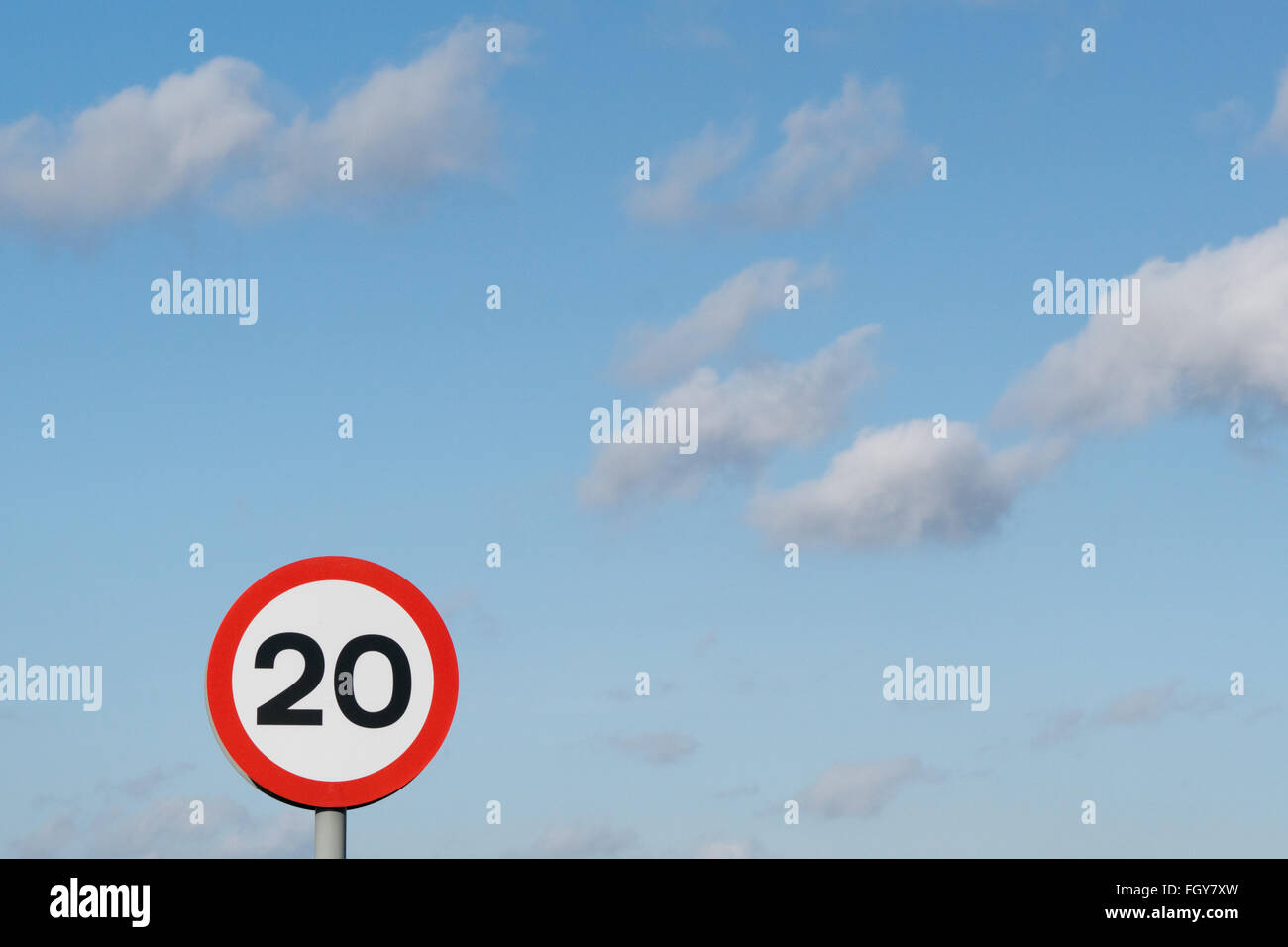 20 mph sign with cloud and blue sky Stock Photo - Alamy